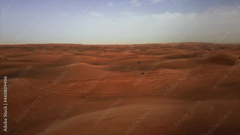 Aerial vertical panoramic view of Dubai desert with racers on bikes and ...