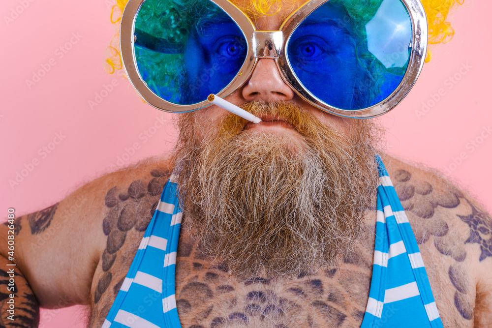 Fat angry man with beard and wig smokes cigarettes Stock Photo | Adobe ...