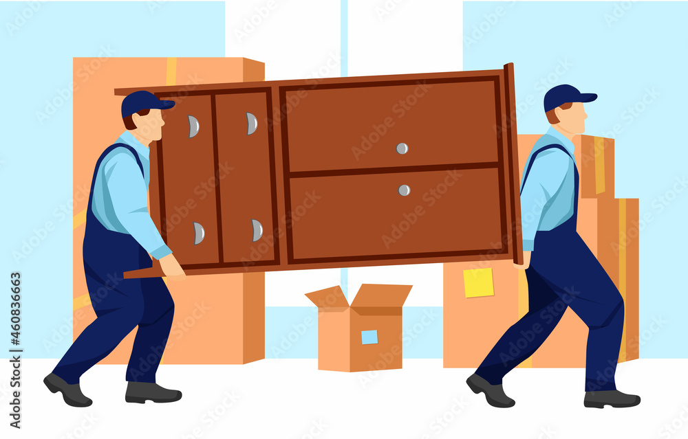 Movers carry a heavy wardrobe. Boxes with things are standing near the ...