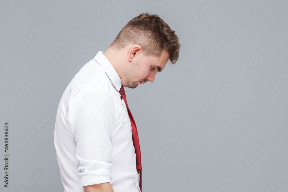 Side view profile Portrait of young handsome sad man in white shirt and ...