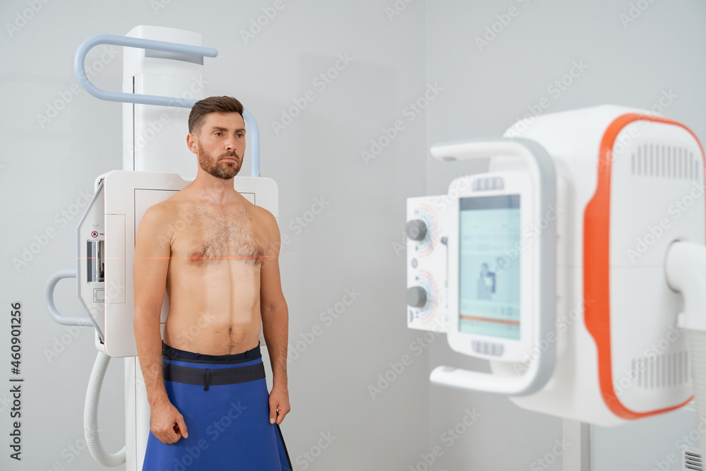 Serious masculine man scanning chest and lungs on ultrasound. Male ...