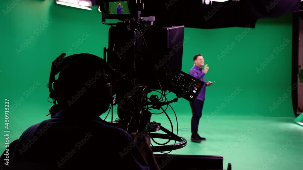 The cameraman follows the announcer in a professional green screen ...