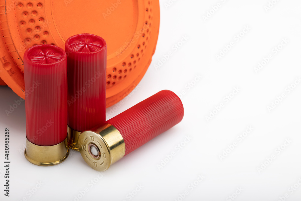 Clay shooting target with shotgun shells on white isolated background ...