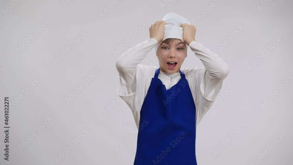 Scared little chef screaming holding head in hands posing at white ...