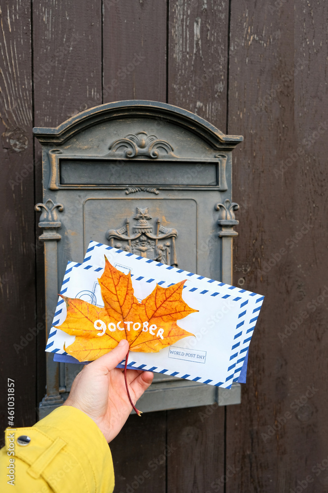 Hand with maple leaf, letters and old mail box. symbol of World Post ...