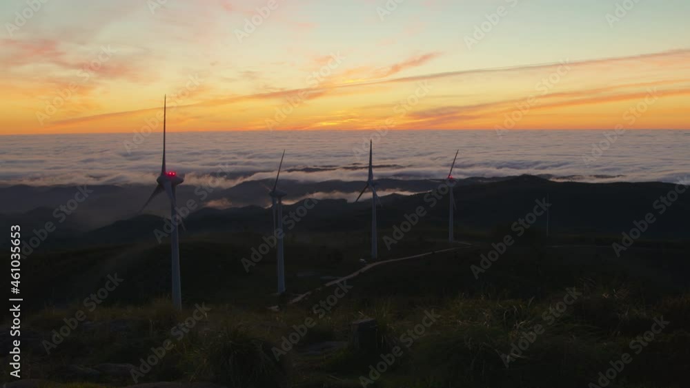 Static shot with copy space of wind turbines turn slowly in epic ...