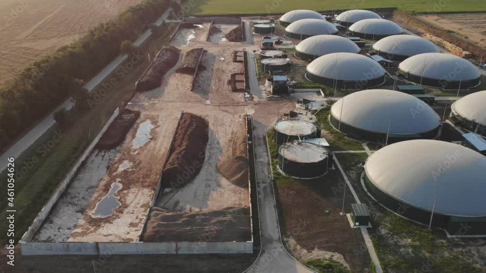 Organic biofuel plant on green field. Modern biogas plant among nature ...