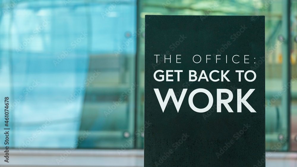 The Office: Get back to Work on a city-center sign in front of a modern ...