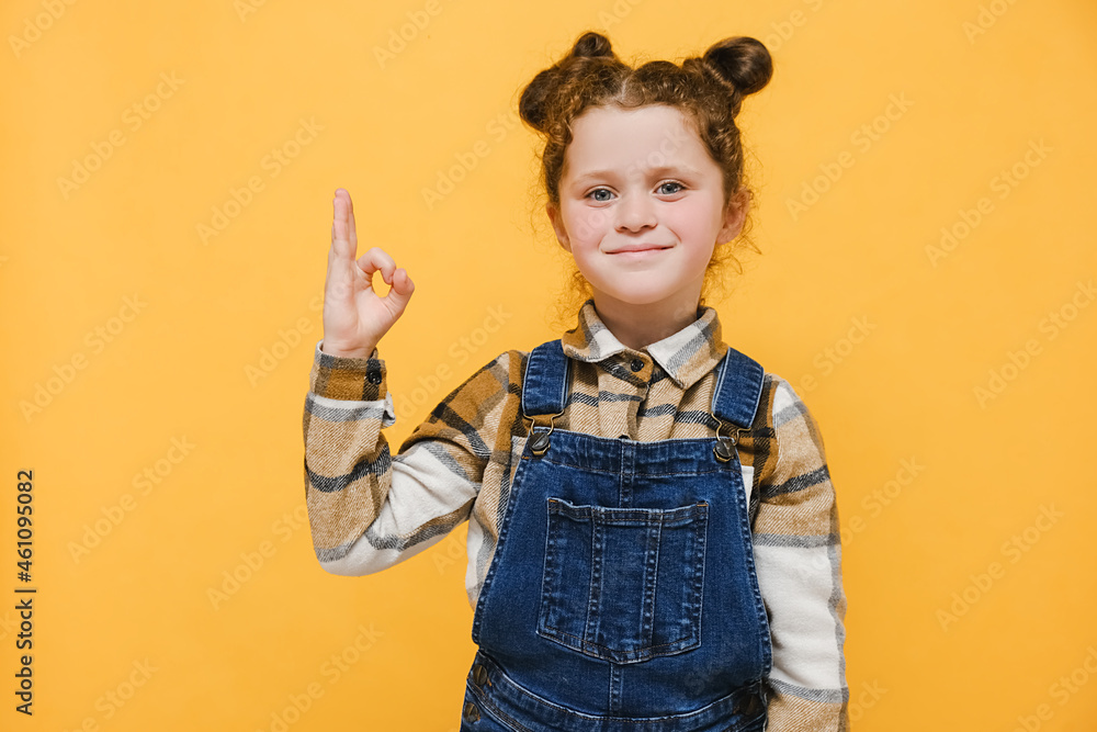 Portrait of little girl child shows ok sign, agrees with something and ...