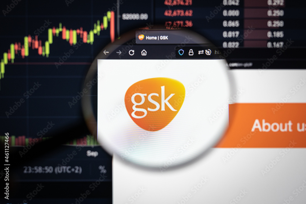 gsk company logo on a website with blurry stock market developments in ...