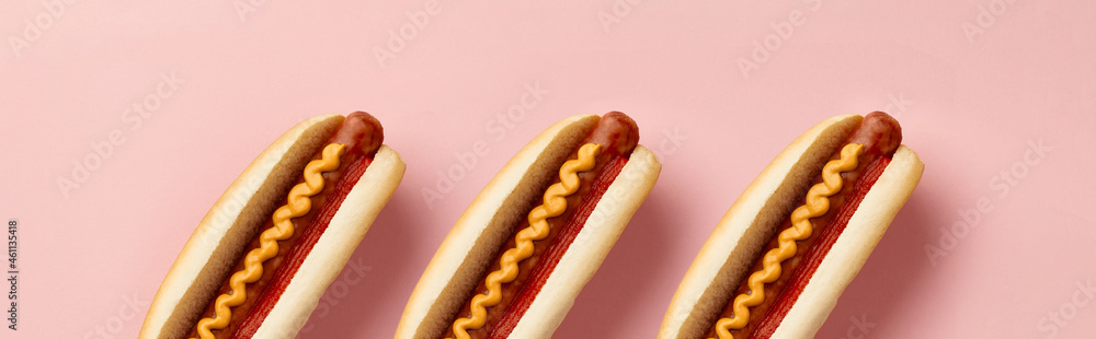 Classic hot dog with wurst, ketchup and mustard on pink table. Menu for ...