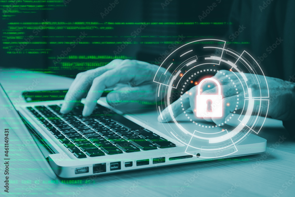 Hacker hand using keyboard typing bad data into laptop computer online system and spreading to ...