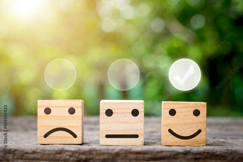 Wooden blocks with happy face smile face symbol symbol on green blurred ...