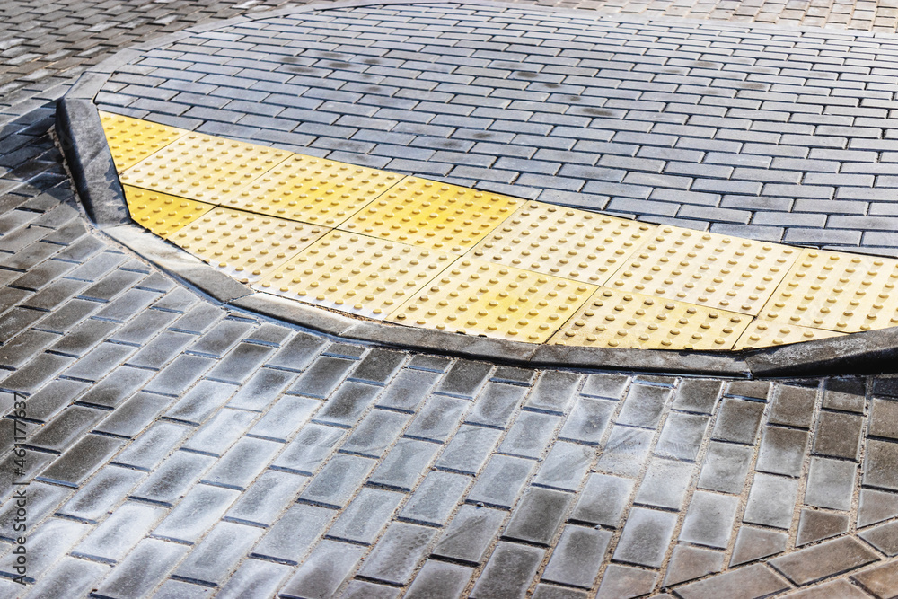 Tactile paving slabs at a pedestrian crossing for visually impaired ...
