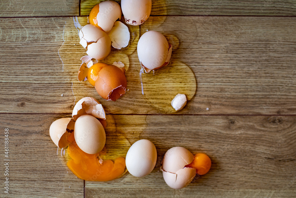 Foto de Many eggs fall down to the floor and broken. An accident in the ...