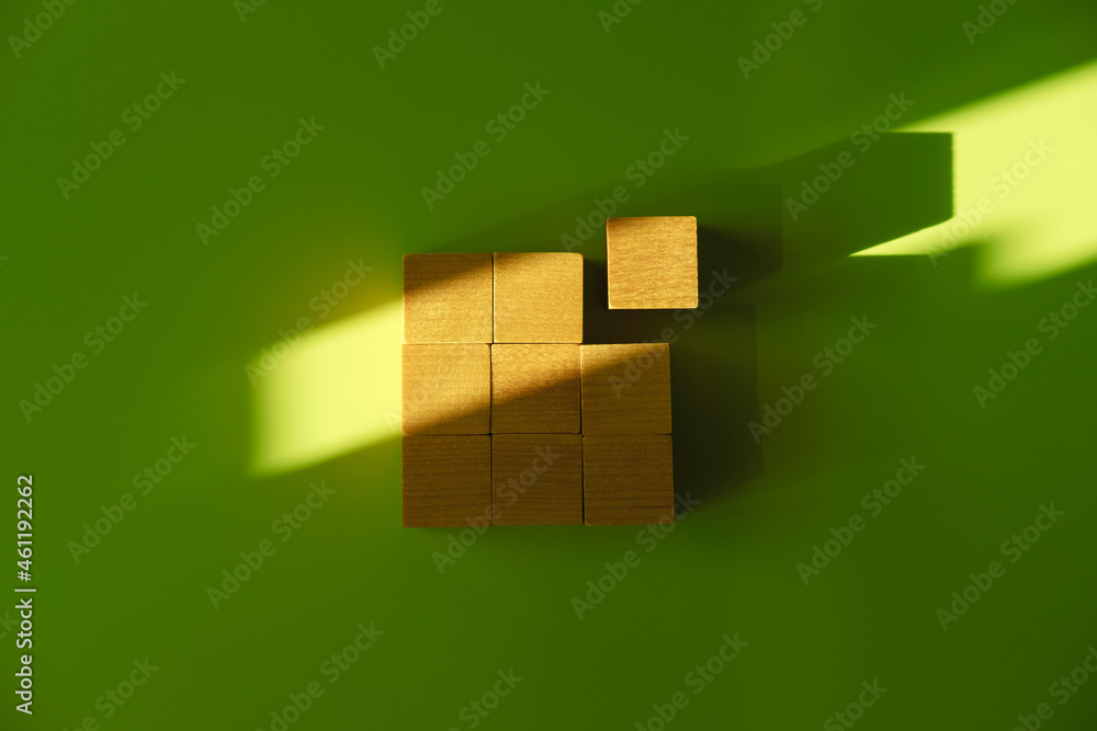 Nine wooden blocks in the form of the square on the green background ...