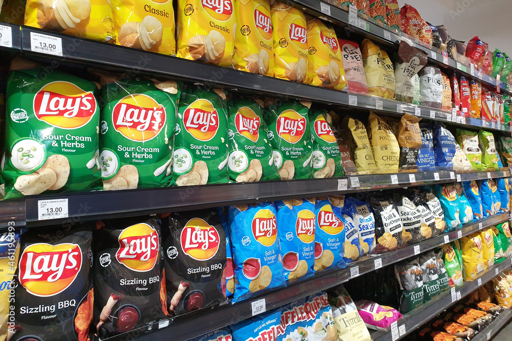 Various local and imported brands of flavoured chips and snacks on ...