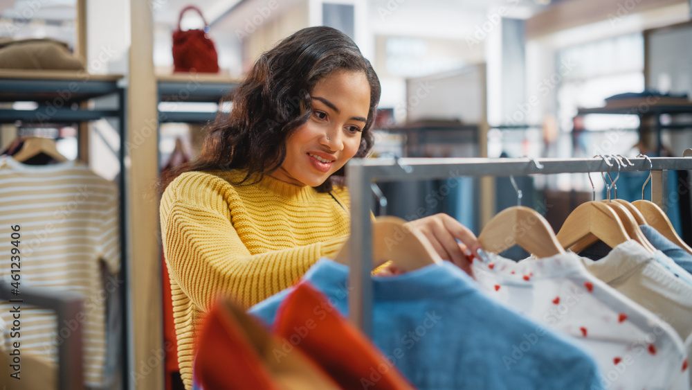 Foto de Beautiful Smiling Female Customer Shopping in Clothing Store ...