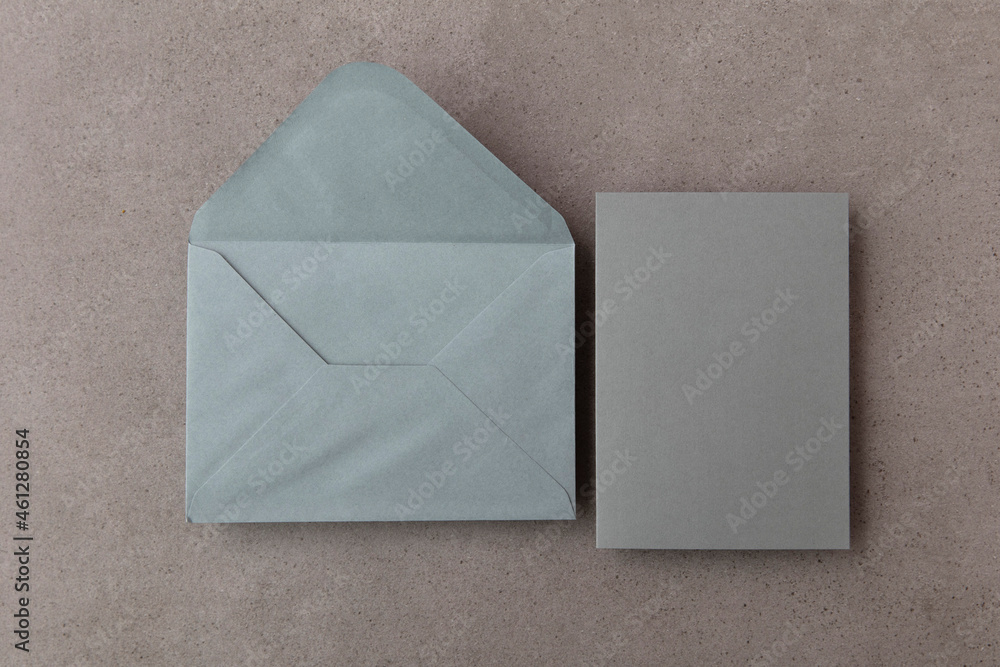 Blank grey card with grey paper envelope template mock up on a concrete ...