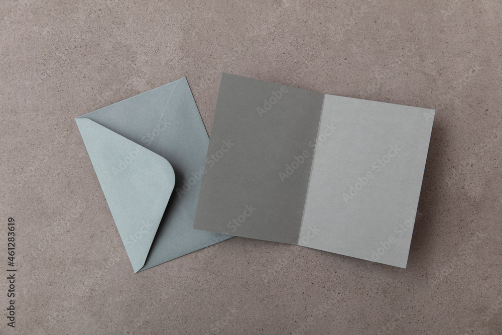 Blank grey card with grey paper envelope template mock up on a concrete ...