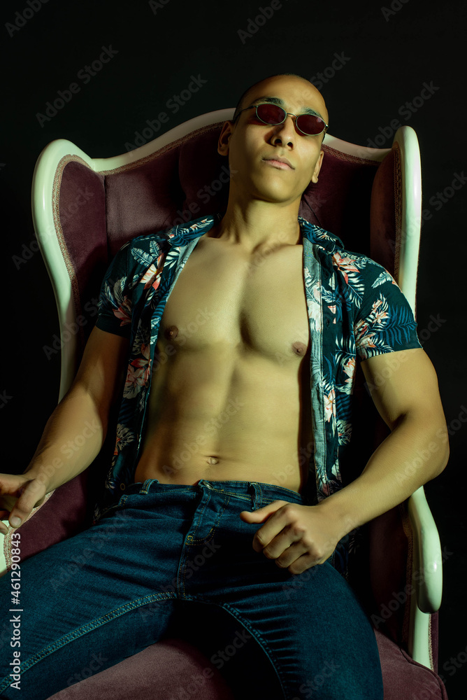 Neon light studio close-up portrait of attractive male model in ...