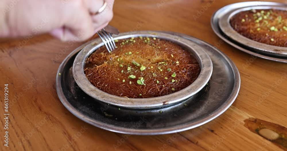 Turkish dessert kunefe, kunafa, kadayif with pistachio powder and ...