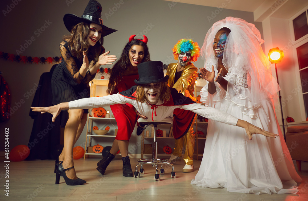 Happy young people dressed up as evil characters having some crazy fun ...