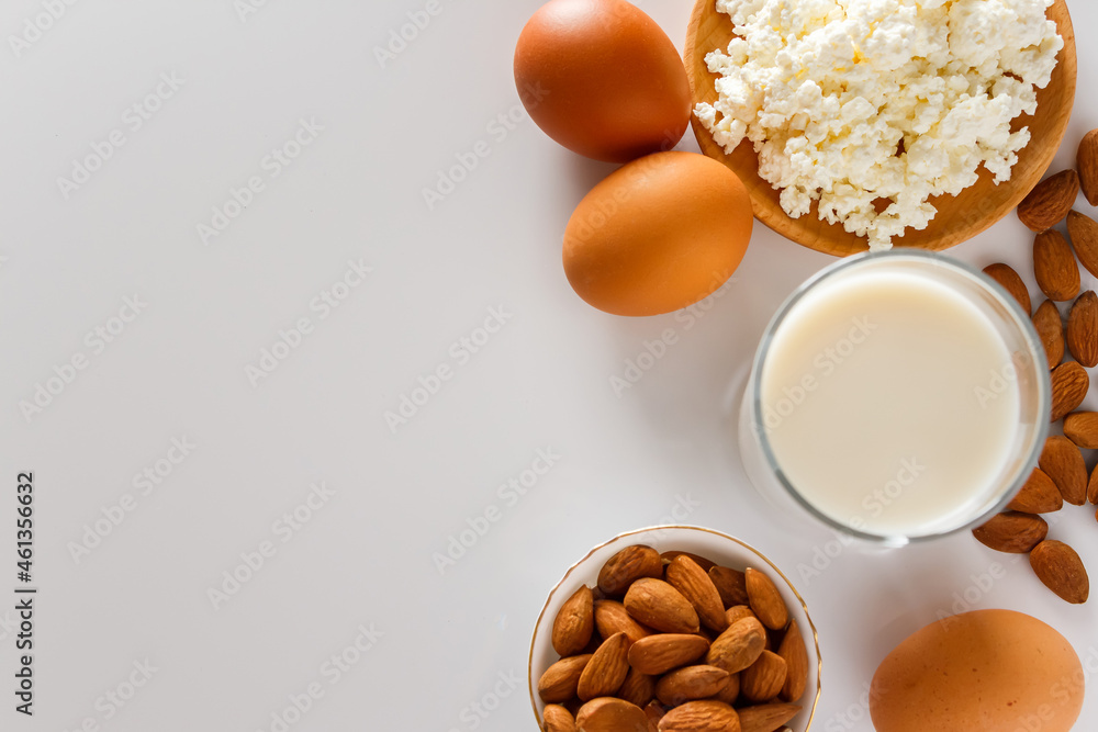Protein food on a white background - cottage cheese, eggs, nuts. A set ...