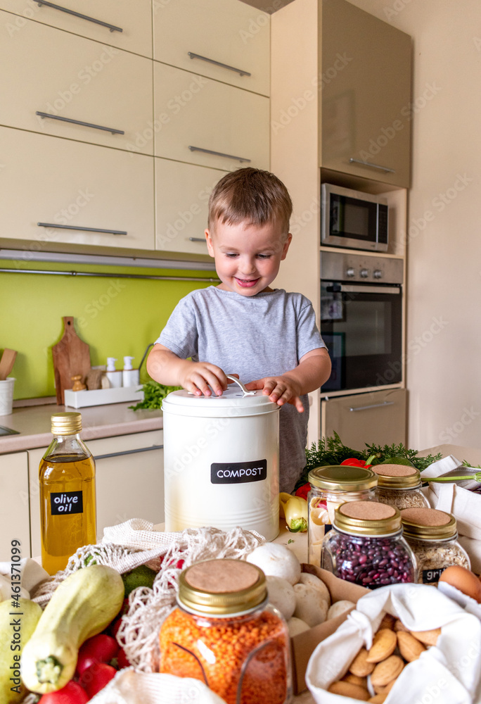 Child boy puts food waste in a compost bin. Waste sorting. ภาพถ่ายสต็อก ...