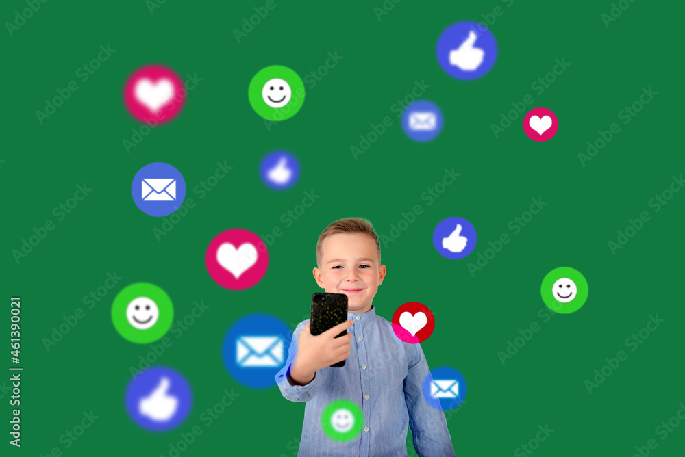 Smiling boy 9s kid using app on smart phone isolated green background ...