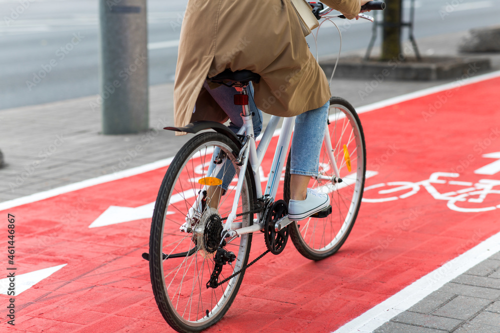 traffic, city transport and people concept - woman cycling along red ...