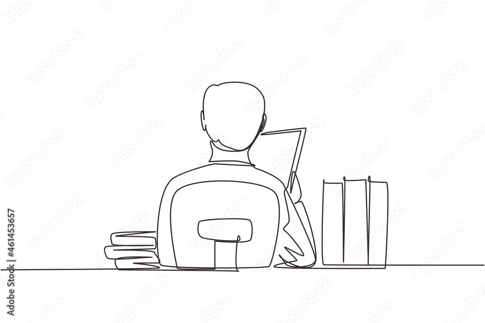 Continuous one line drawing back view of young man sitting at desk and ...