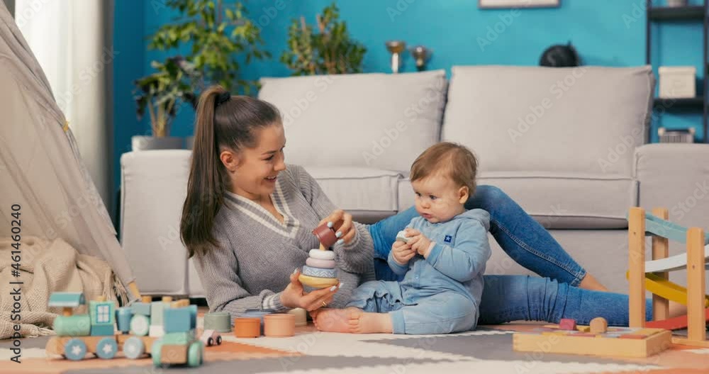Sister lies on mat on living room floor next to little polite brother ...