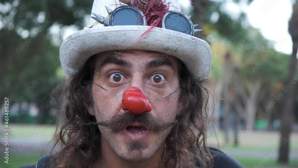 Clown playing with mustache and smiling to camera. Steampunk dirty ...