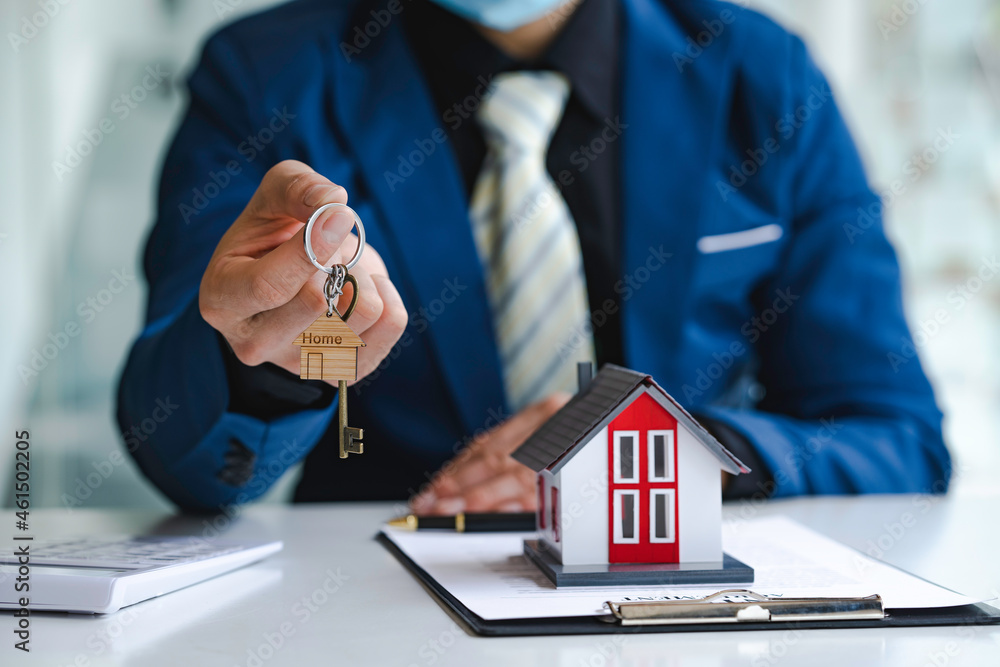 Real estate agent passing house model to his client, Hand of real ...