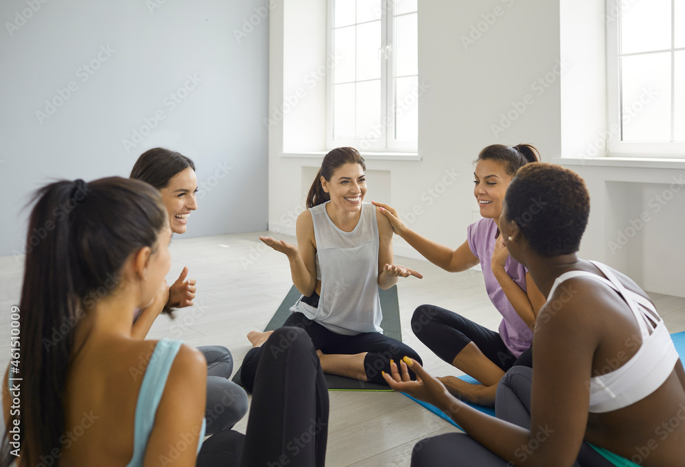 Training with a friend. Group of athletic multicultural women during a ...