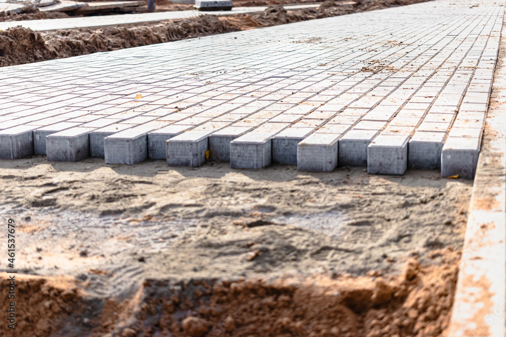 Pavement repair and laying of paving slabs on the walkway, stacked tile ...