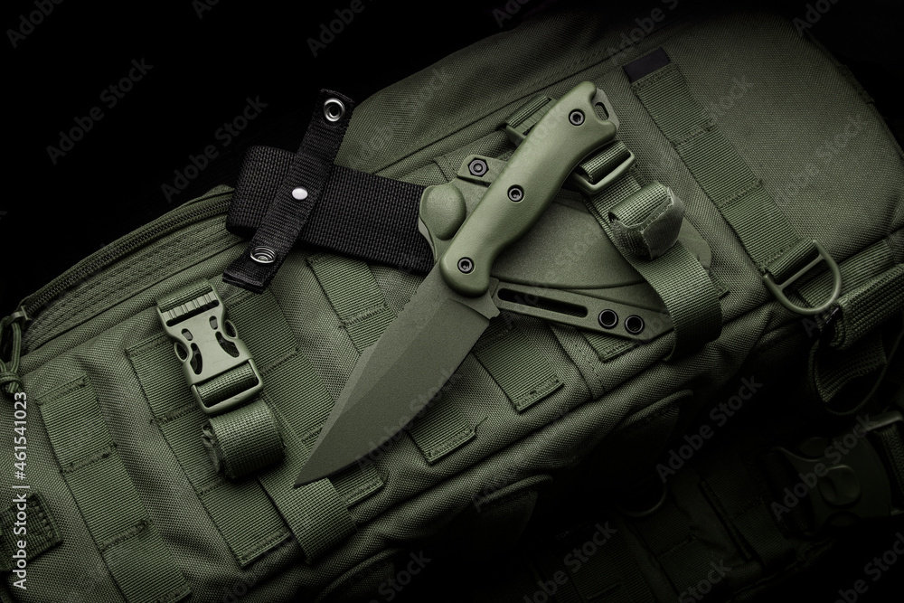 A modern military knife and a plastic sheath for it. Edged weapons lie ...