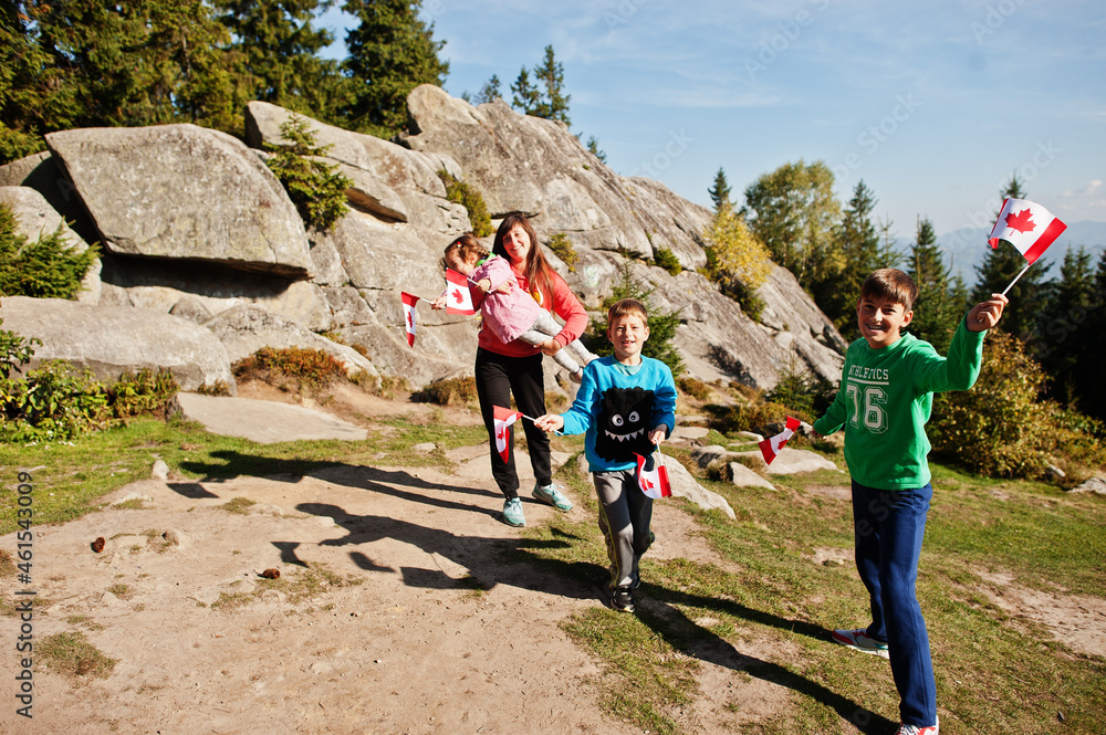 Happy Canada Day. Family of mother with three kids hold large Canadian ...
