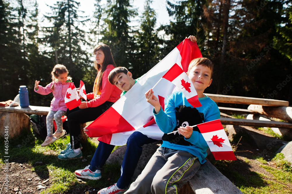 Happy Canada Day. Family of mother with three kids hold large Canadian ...