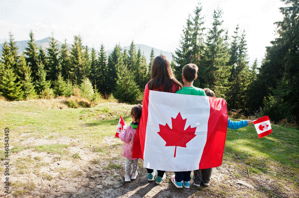 Happy Canada Day. Family of mother with three kids hold large Canadian ...