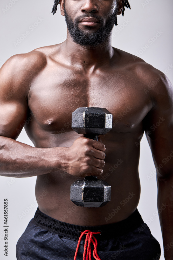 Attractive african male power lifter posing with dumbbells isolated in ...