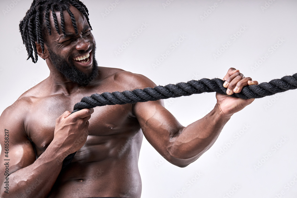 handsome fit bearded afro sportsman yelling and pulling rope isolated ...