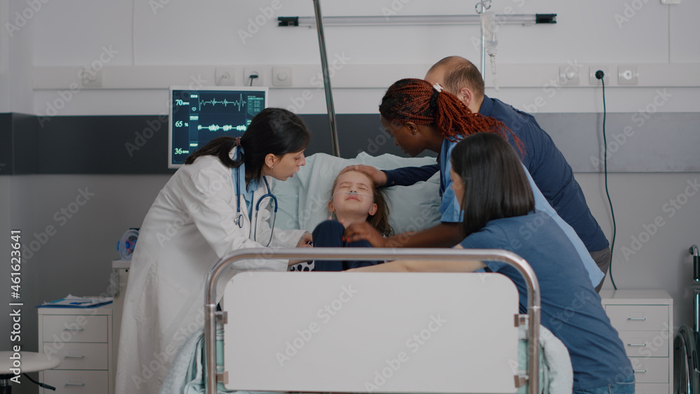Pediatrician woman doctor holding sick little child monitoring disease ...