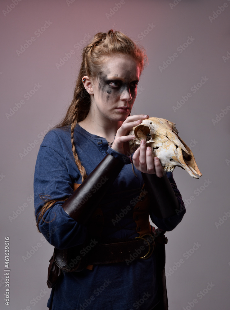 Closeup portrait of young red haired woman with black barbarian ...