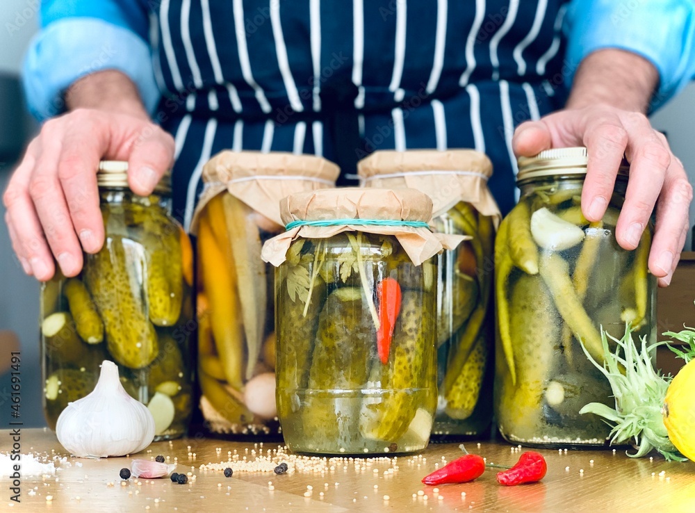 Artisanal. A man is doing pickles jars stock for winter season. Organic ...