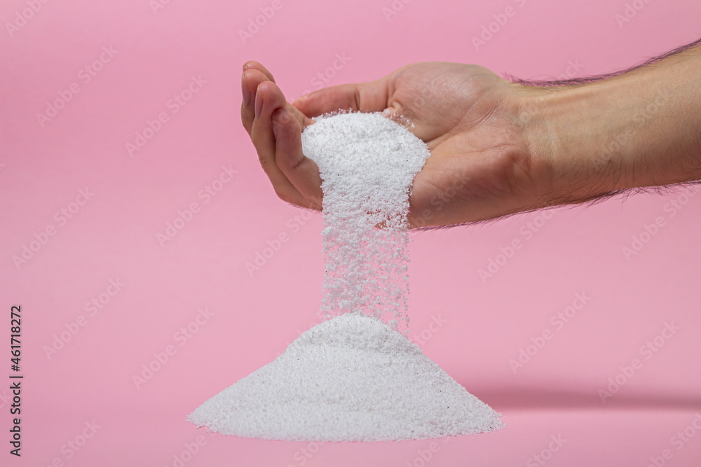 Washing powder on a pink background. Detergent for washing clothes ...