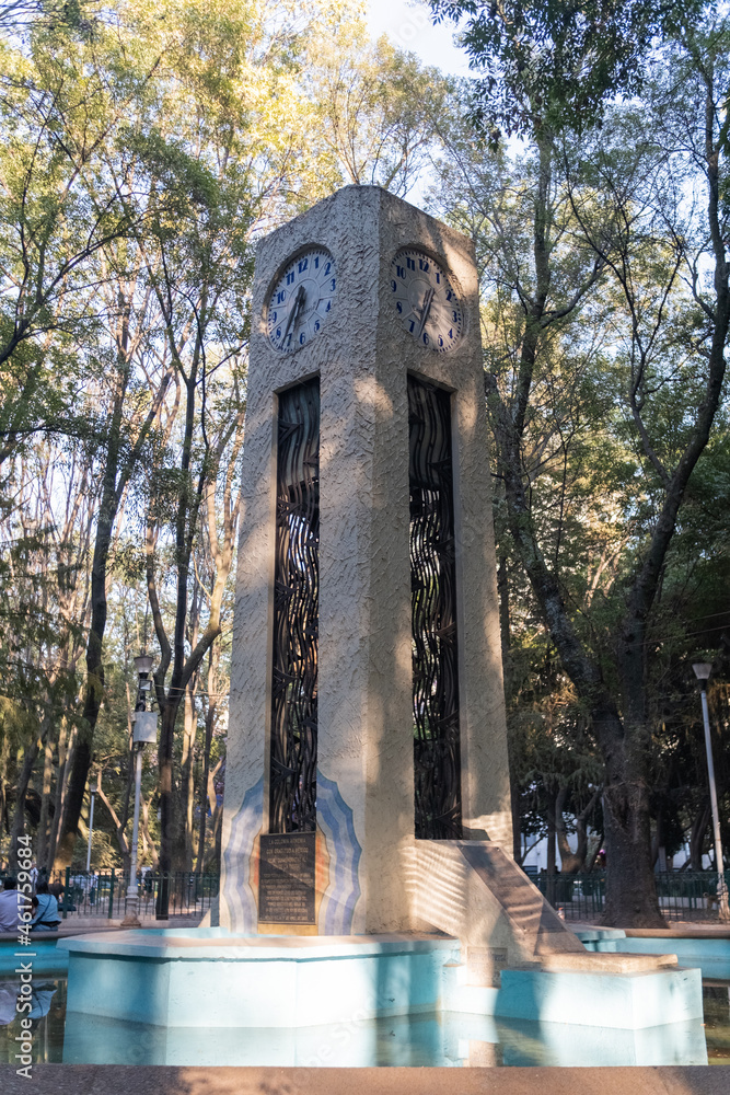 Small clock tower with trees and bright sunlight as background Stock ...
