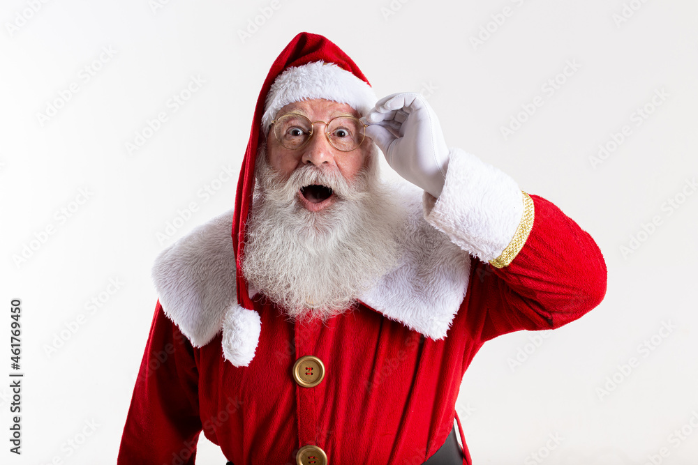 Santa Claus in eyeglasses is looking surprised at camera on white ...