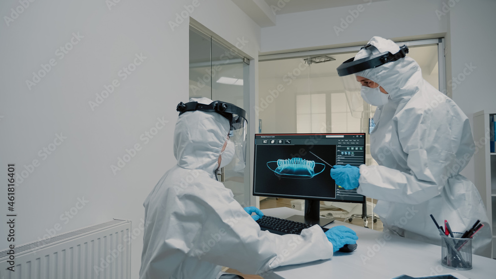 Professional stomatology team analyzing teeth x ray on computer screen ...